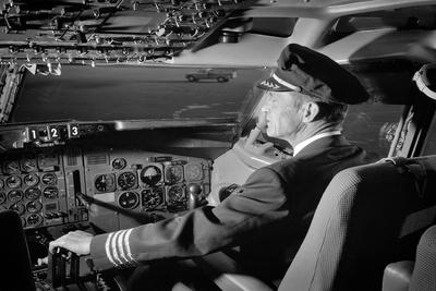 '1960s AIRPLANE PILOT HAND ON CONTROLS IN COCKPIT OF AIRLINE AIRCRAFT ...