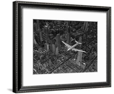 Aerial View of a DC-4 Passenger Plane Flying over Midtown Manhattan ...