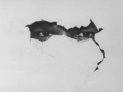 'African American Man's Eyes Peering Through Torn Paper Symbolizing ...