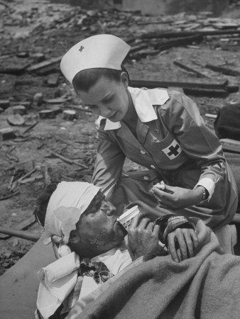 'The Red Cross Nurse Trying to Help the Injured Man Eat and Drink ...
