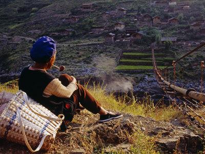 'Smoking Her Pipe, a Naxi Woman Rests after Crossing a Precarious Pipe ...
