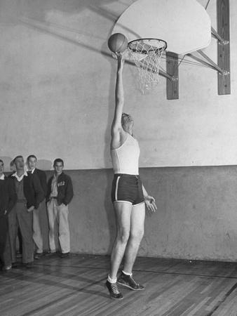 'Basketball Player Max Palmer Reaching Up to Drop Basketball into ...