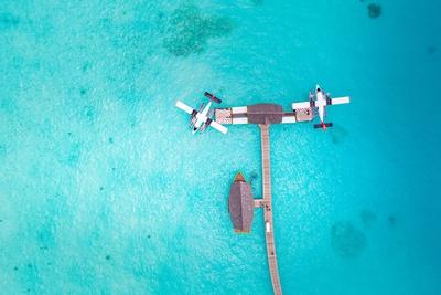 Beautiful aerial view of Maldives jetty seaplane top view with wooden ...
