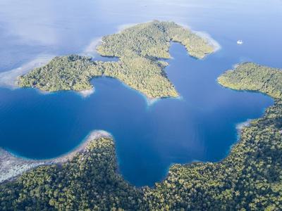 Beautiful, tropical islands rise from the seascape in Raja Ampat ...