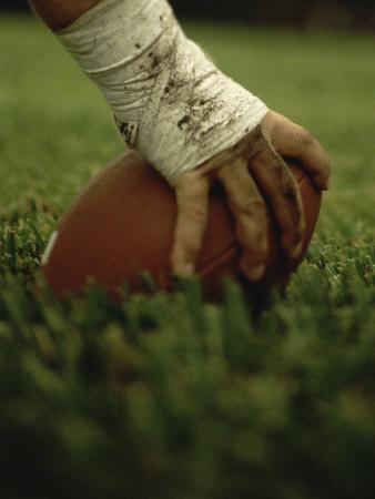 'Close-up of the Hand of an American Football Player Holding a Football ...