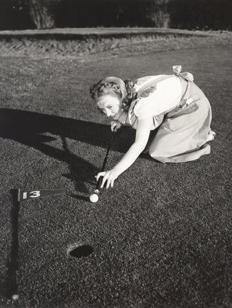 Female Golfer Crouching to Line Up a Shot Photo | Art.com