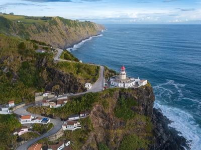 Aerial view of Farol do Arnel lighthouse and fishermen huts, Sao Miguel ...