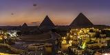 View of Giza Pyramids from rooftop terrace at dusk, Cairo, Egypt ...