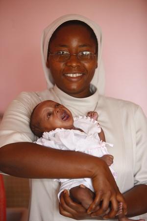 Franciscan sister holding an orphan at nursery and kindergarten run by ...