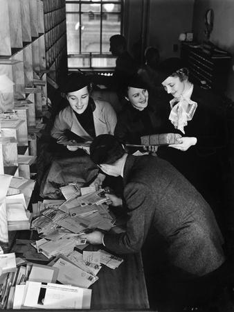 'Group of People Going Through a Pile of Mail' Photo | Art.com