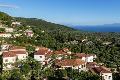 'View over rooftops of homes in village of Vuno, towards Ionian Sea ...