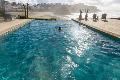 'Woman swimming in infinity pool by Atlantic Ocean, Hotel auberge Dar ...
