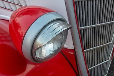 'Detail of head light and grill on red classic American Ford in Habana ...