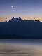'USA, Washington State, Seabeck. Crescent moon at sunset over Hood ...