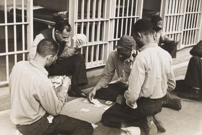 'Inmates playing cards sitting on floor outside cells' Photographic ...