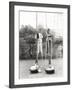 'Man and Woman on Stilts Holding Giant Golf Clubs' Photo | Art.com