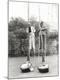 'Man and Woman on Stilts Holding Giant Golf Clubs' Photo | Art.com