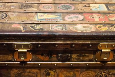 'Old steamer trunk covered with stickers of various destinations ...