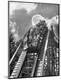 '1950s GROUP OF TEENS ON ROLLER COASTER COMING OVER AND DOWN THE TOP OF ...