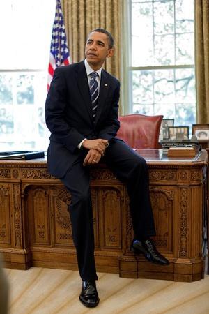 'President Barack Obama Sits on the Edge of the Resolute Desk in the ...