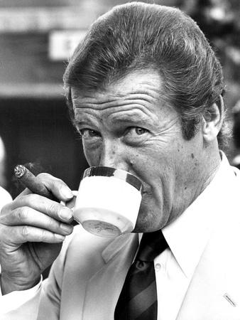 'Roger Moore Drinking Coffee' Photo - Associated Newspapers | Art.com