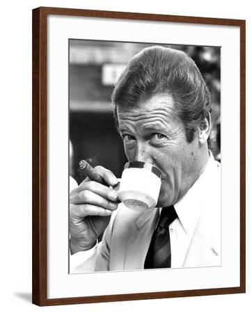 'Roger Moore Drinking Coffee' Photo - Associated Newspapers | Art.com