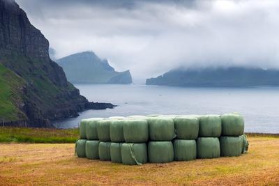 Rural scene with farm field and hay stacks on the Gasadalur village ...