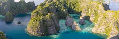 Seen from above, remote islands are surrounded by coral reefs in Raja ...