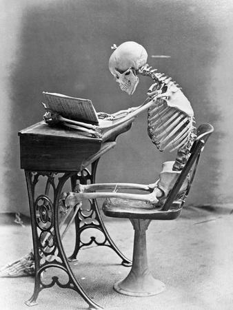 Skeleton Sitting Behind Desk
