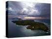 Storm clouds dump rain near a remote tropical island in the Solomon ...