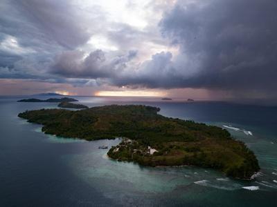 'Storm clouds dump rain near a remote tropical island in the Solomon ...