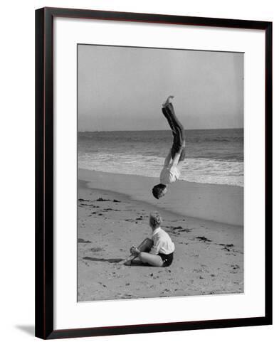 Acrobat/Actor, Russ Tamblyn Doing a Flip on Beach with Movie Actress ...