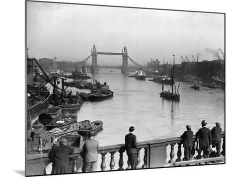 Pedestrians on London Bridge Watch Boats and Barges Being Unloaded ...
