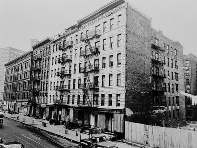 'East Harlem's 100th St. with a Large Tenement Apartment Building in ...