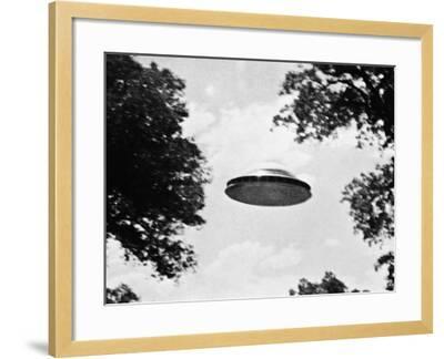 UFO Flying Low over Trees Photographic Print by | Art.com