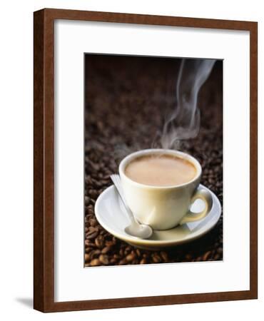 A Steaming Cup of Coffee on Coffee Beans Photographic Print by Peter ...