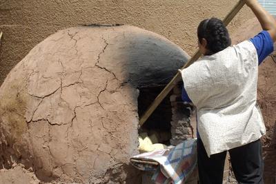 'Zuni Pueblo Woman Baking Bread in an Horno at the Gallup Intertribal ...